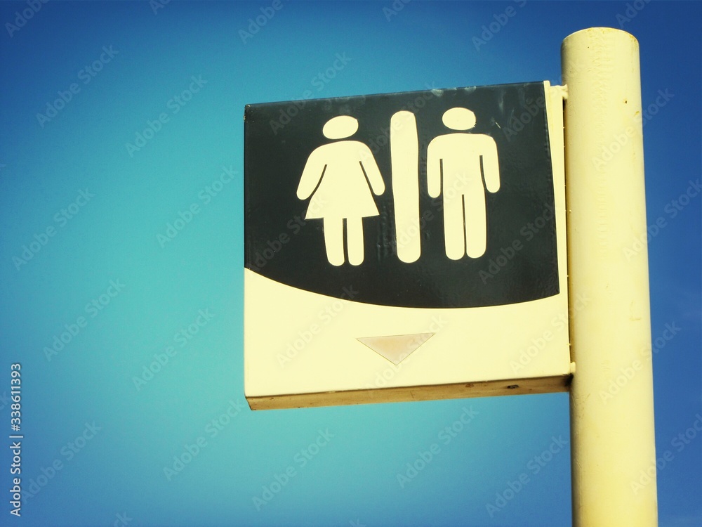 Restroom Sign On Flag Against Blue Background Stock Photo | Adobe Stock