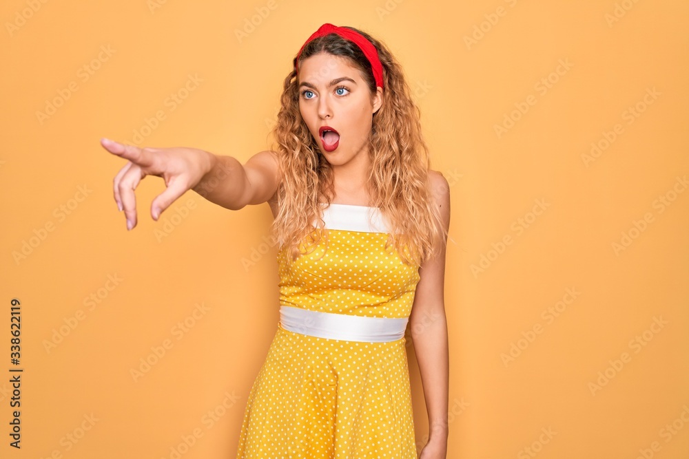 Beautiful blonde pin-up woman with blue eyes wearing diadem standing ...