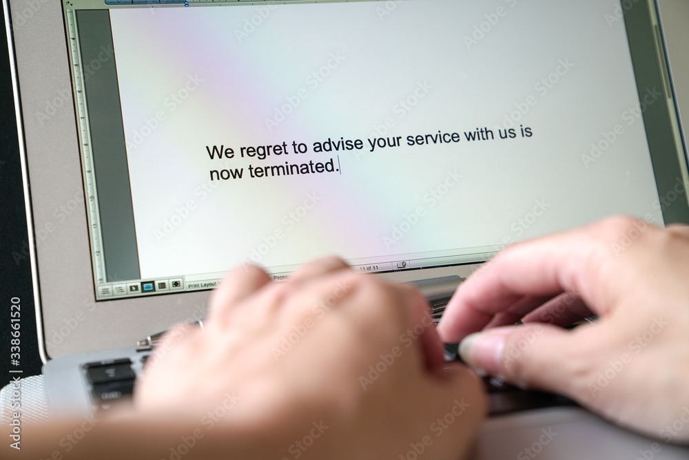 Woman typing letter of termination of service on the computer Stock ...