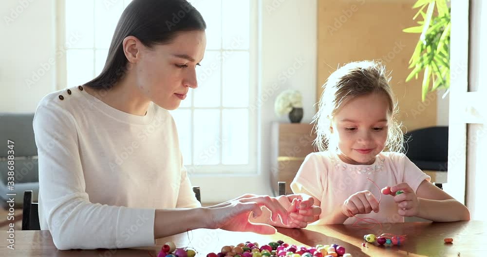 Head shot caring millennial babysitter nanny creating handmade ...