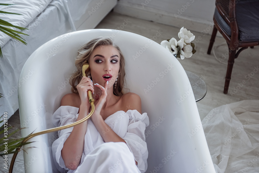 Beautiful modern bride in a wedding dress is having fun and posing in ...