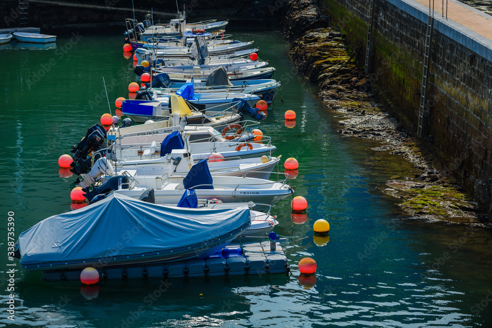 Fishing boats with buoys in the port of Armintza. Basque Country ...