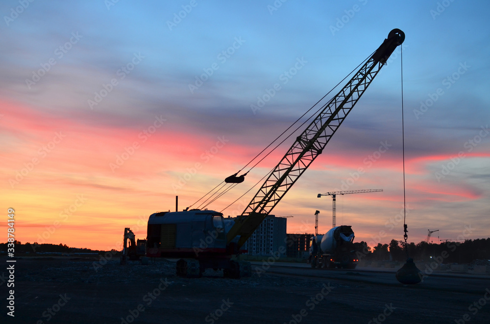 Crawler crane with a heavy metal wrecking ball on a steel cable ...