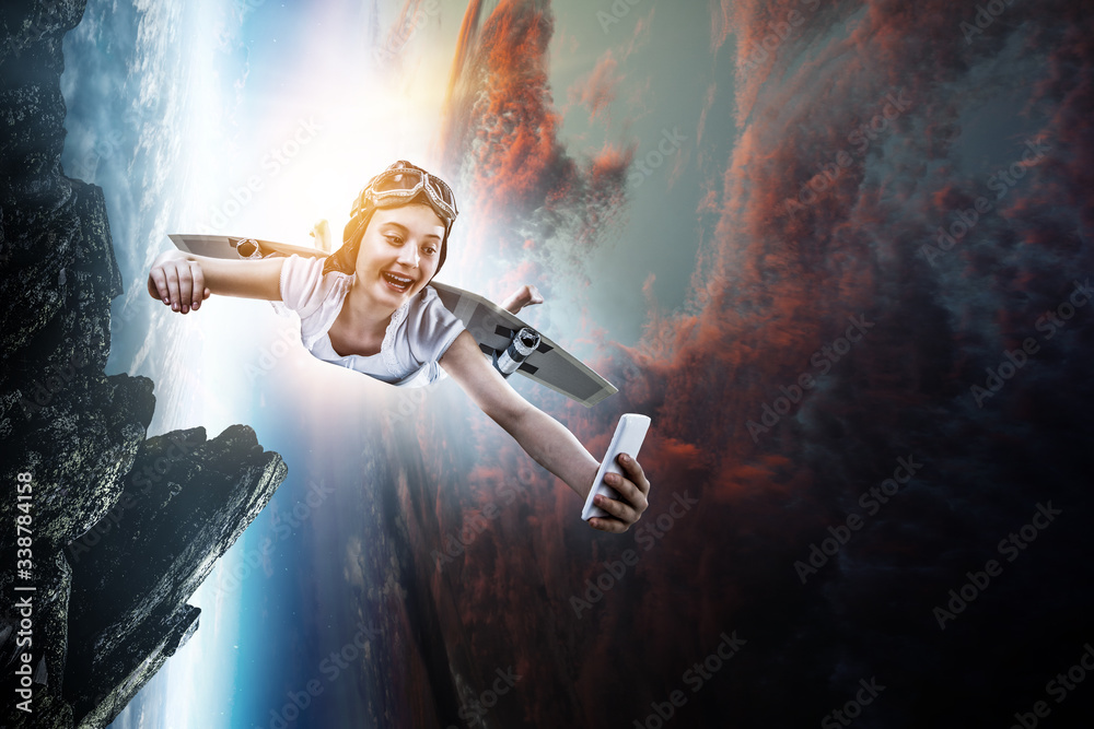 Girl flying with self-made plane wing. Mixed media Stock Photo | Adobe ...