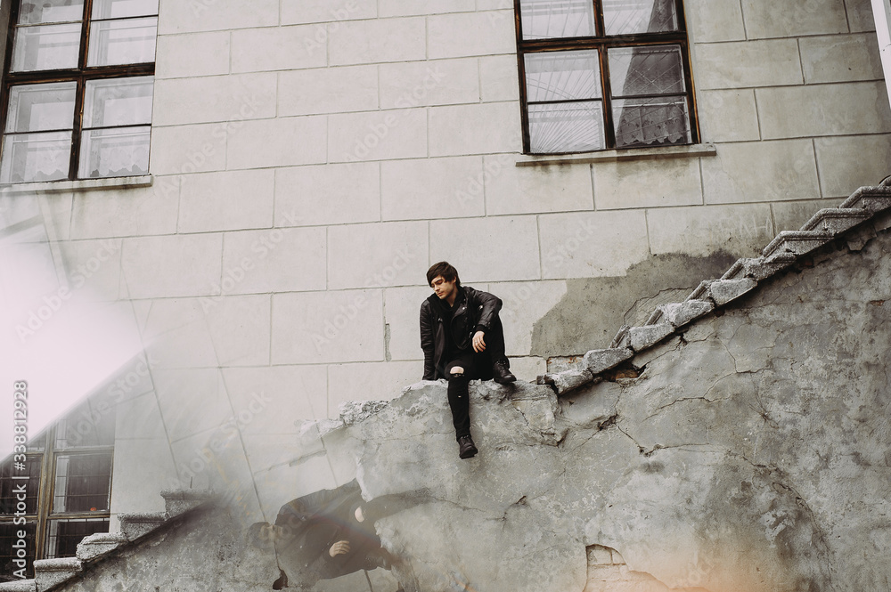 Emotional portrait of a guy on the ruins. Emotions, depression, stress ...