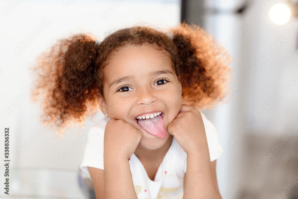 Cute little kid girl watching video on smartphone with smiley face ...