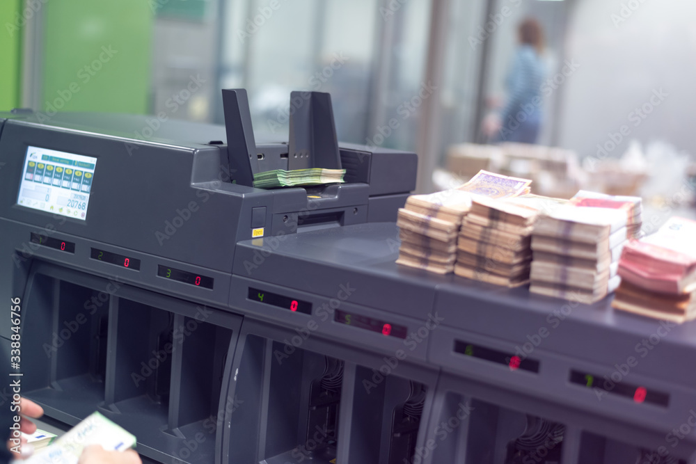 Bundles of banknotes divided into groups with currency straps placed on ...