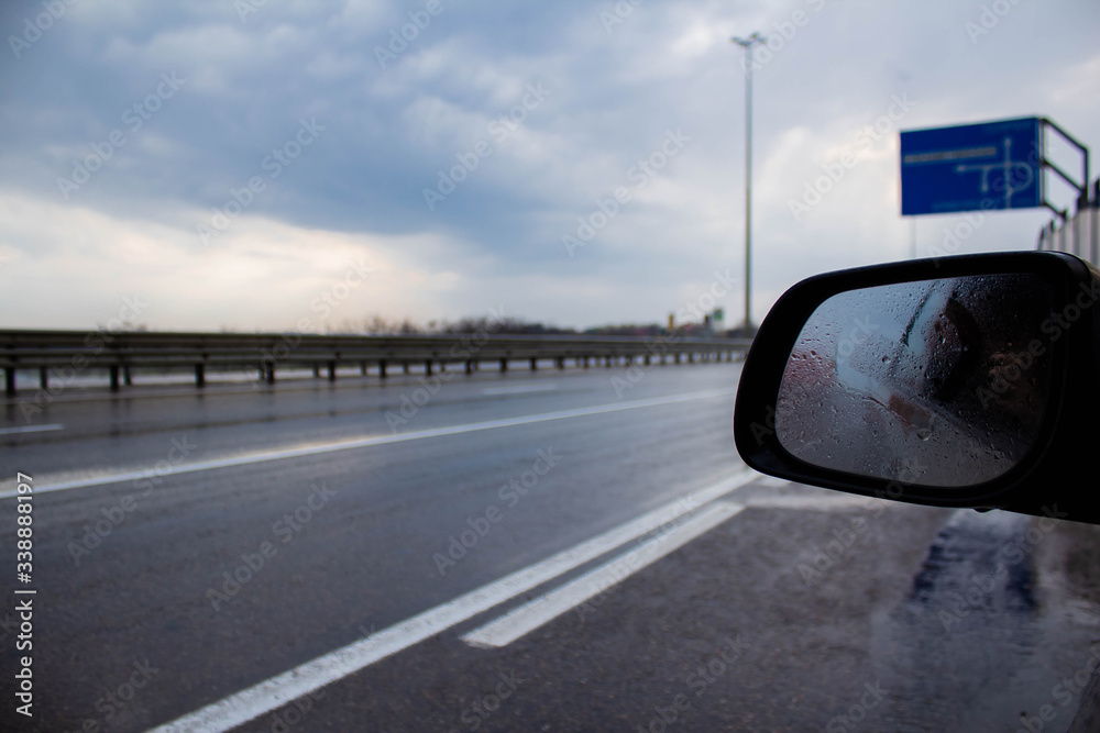 Long wet road. View of the road in the rain from the car window. A ...