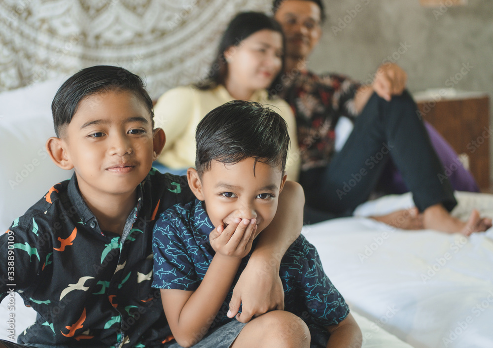 Southeast Asian family spending time at home. Happy Indonesian parents ...