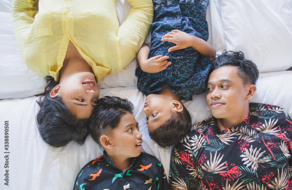 Southeast Asian family spending time at home. Happy Indonesian or ...