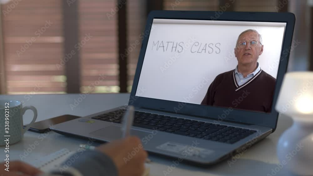 Learning through online lessons. Mature teacher presents e-learning ...