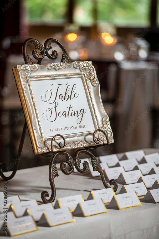 Folded name card in script writing and gold trim on a table for a ...