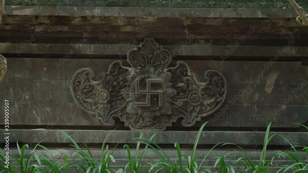 A great shot of an ancient carved swastika at a hindu temple in the ...