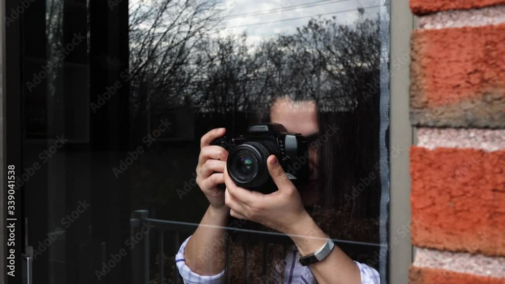 Vidéo Stock Caucasian girl stalking out of her window, from her house ...
