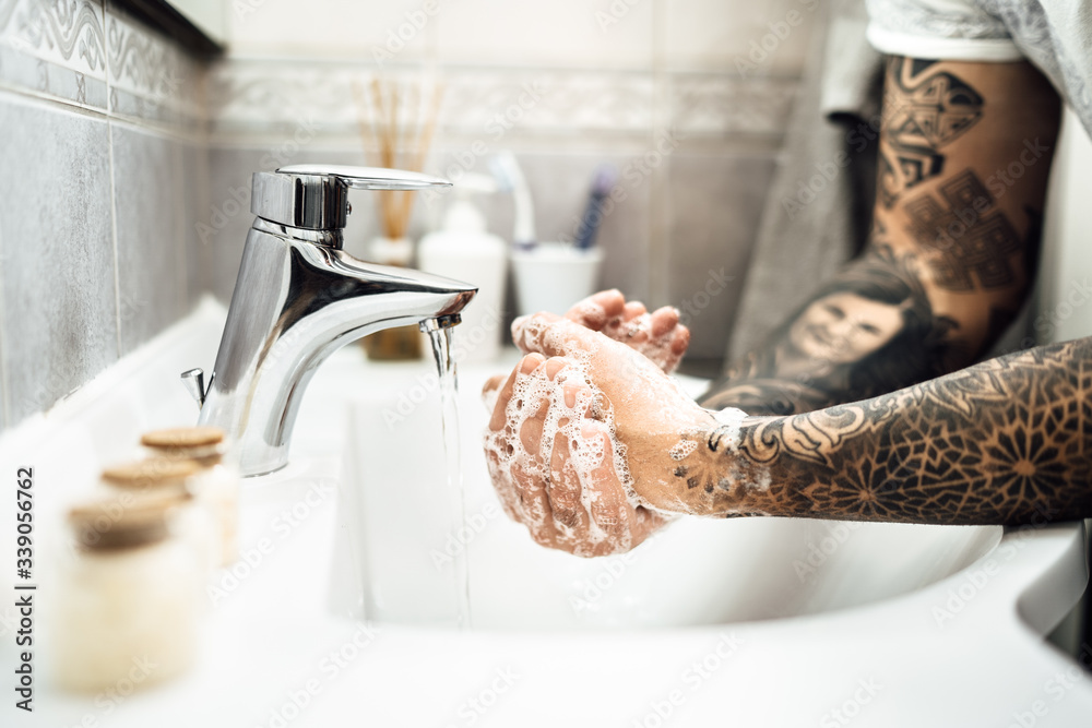 Man washing hands with soap and water in clean bathroom.Decontamination ...