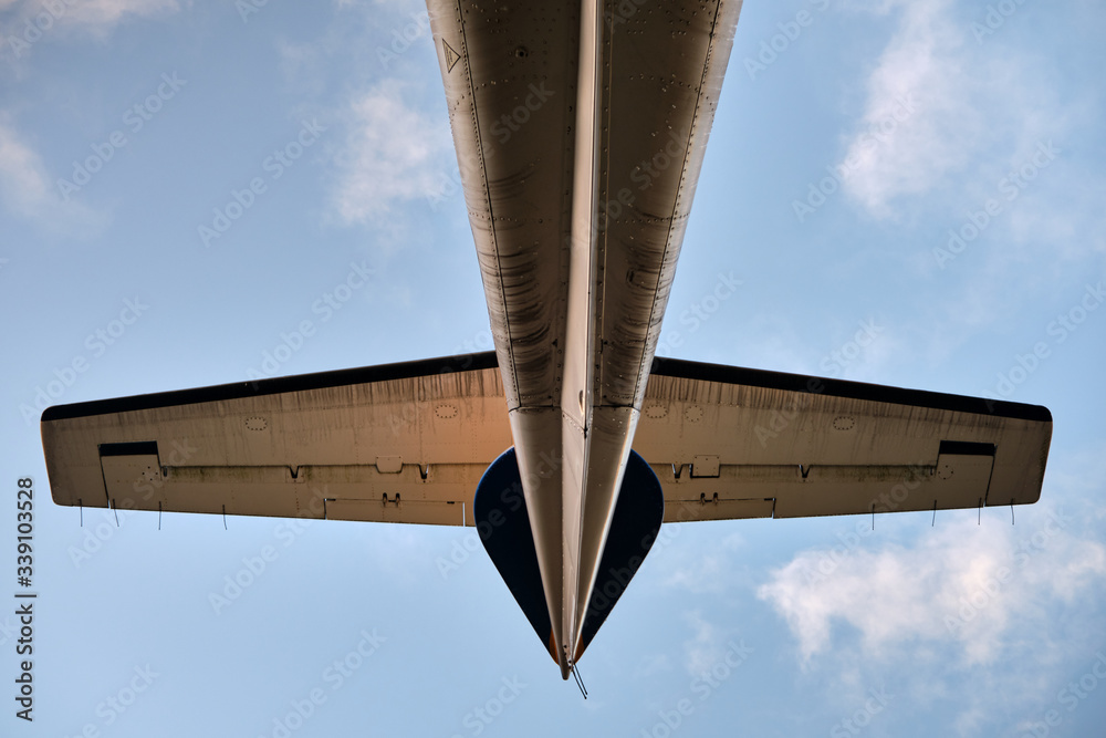 Tail of an aircraft with elevator and a brilliant blue sky background ...