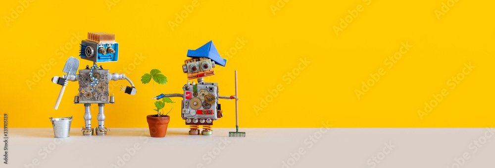 Smart garden robotics technology. Two happy breeder gardener robots ...