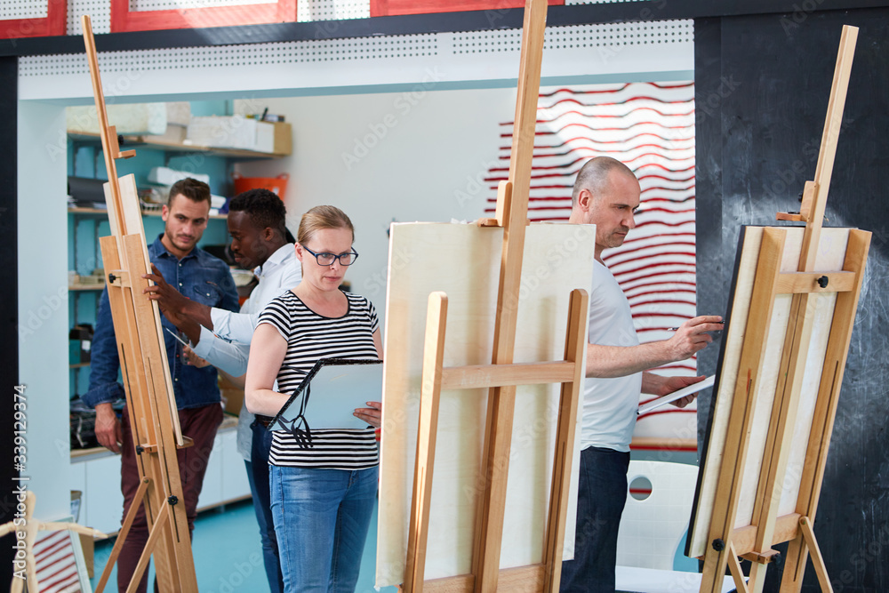 People in a painting class for beginners at the easel Stock Photo ...