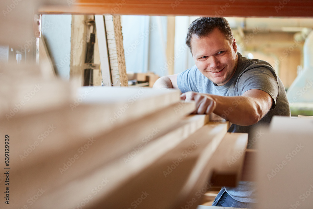 Carpenter fetches wood from the carpentry warehouse Stock Photo | Adobe ...