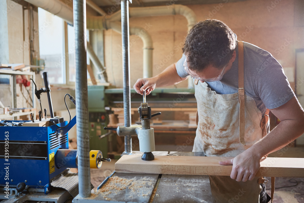 Furniture maker with wood board on a drill Stock Photo | Adobe Stock