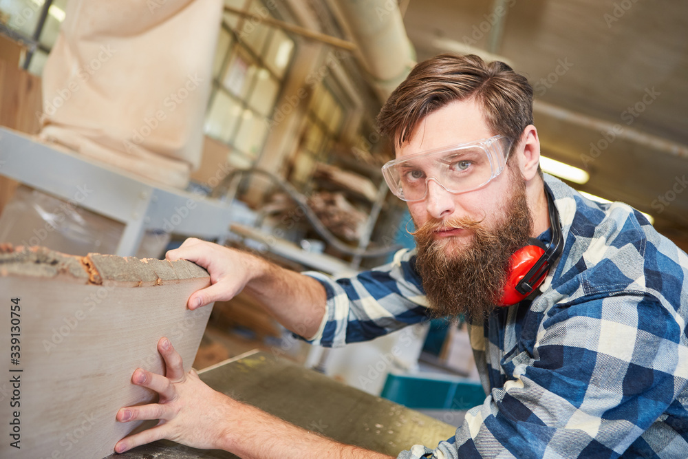 Hipster carpenter with beard training in planing Stock Photo | Adobe Stock