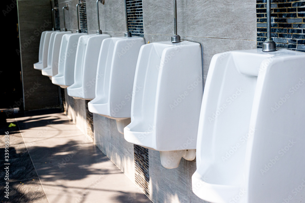 Men's white urinals design, Close up row of outdoor urinals men public ...