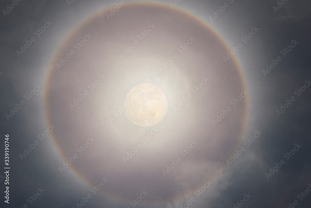 Super moon with a circular rainbow halo around the moon formed by the ...