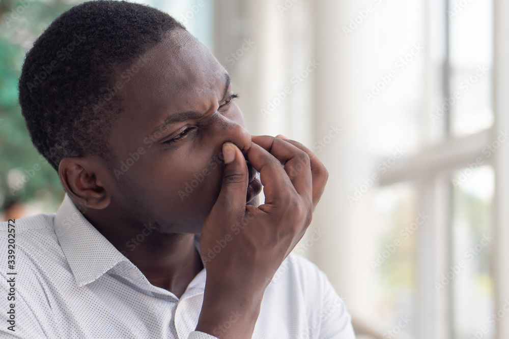 African black man covering his nose for bad smell; African black man ...