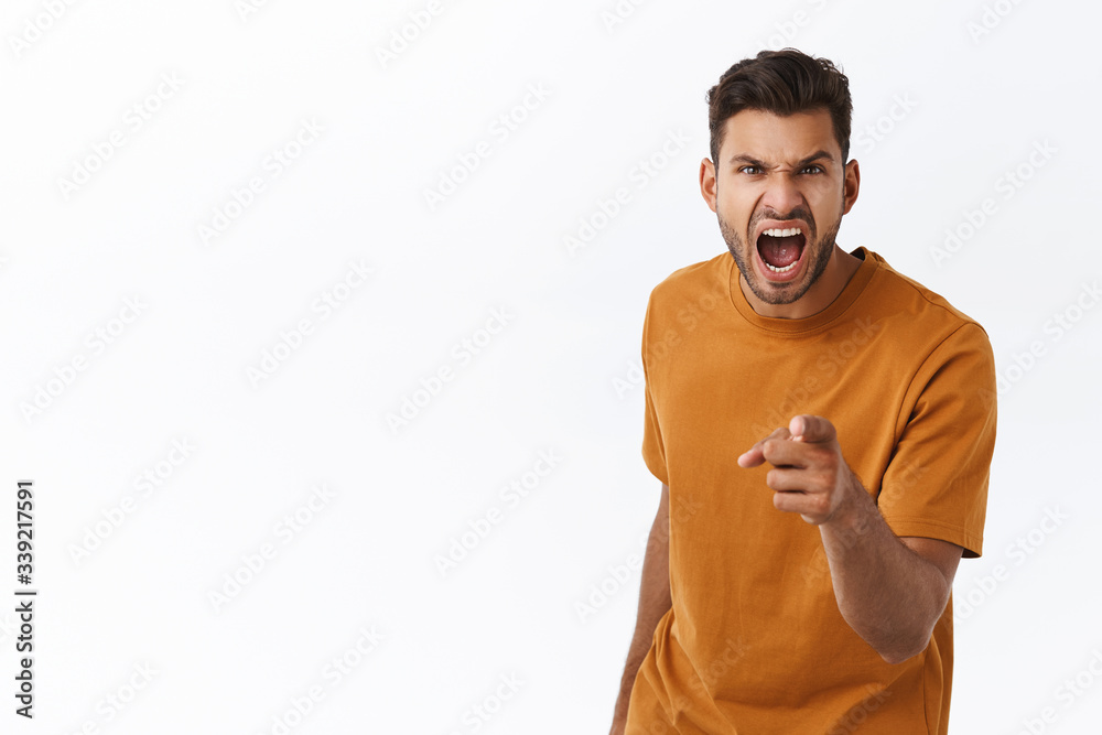 Angry, distressed outraged young man with beard, losing temper and ...