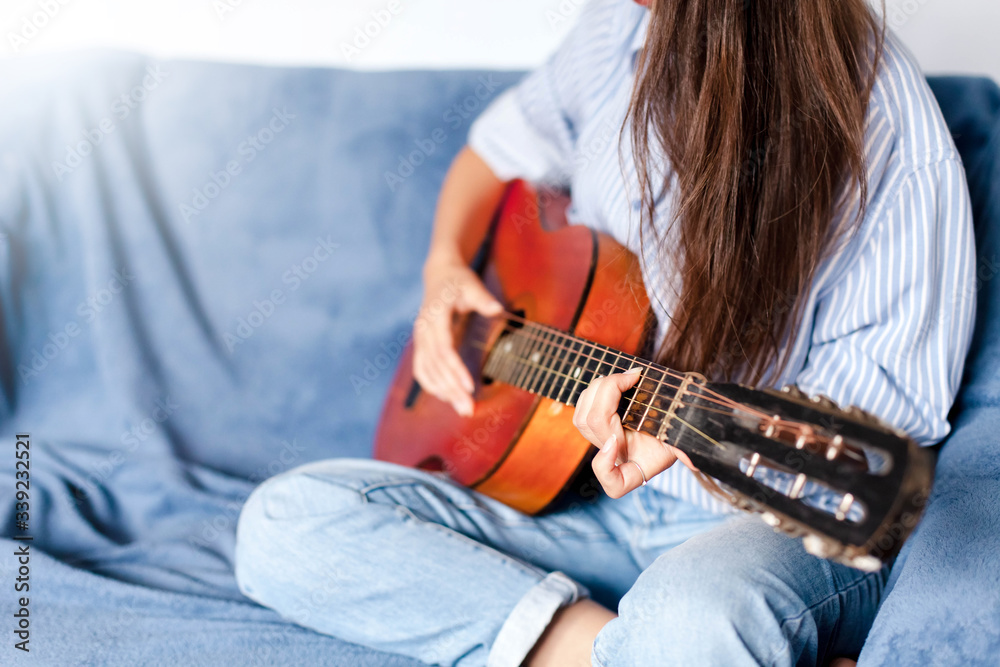Young woman playing guitar at home. Happy girl enjoying music. Female ...