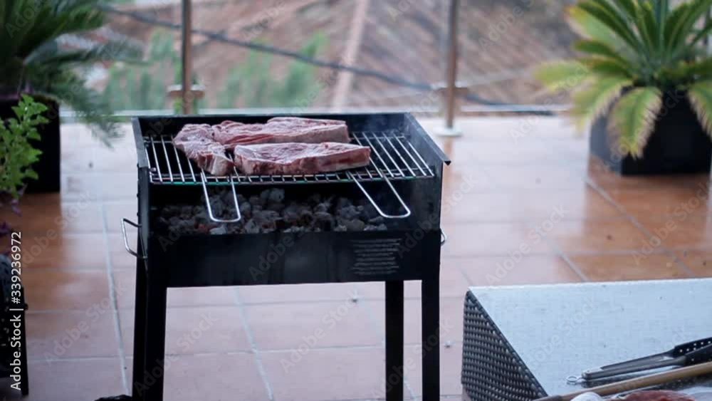 barbecue cooking some delicious beef steaks, they are still raw but ...
