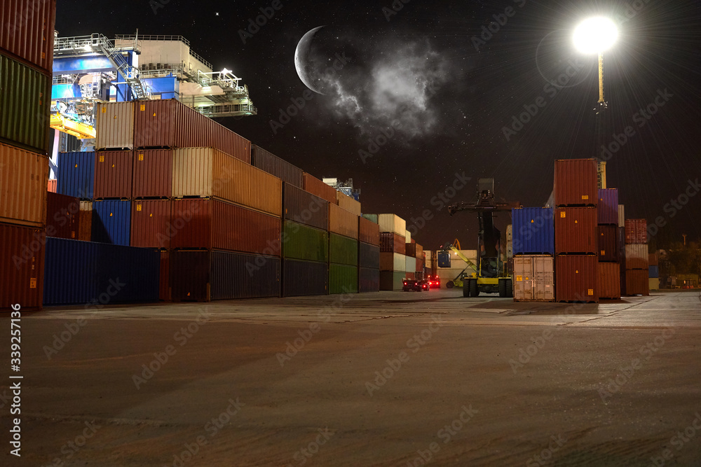operation of container terminal at night. Unloading container ship at ...