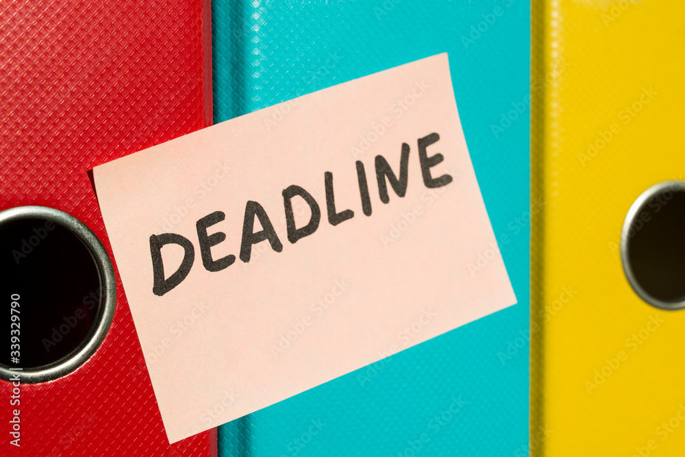 Deadline. Records management. Thick folders with documents on which a ...