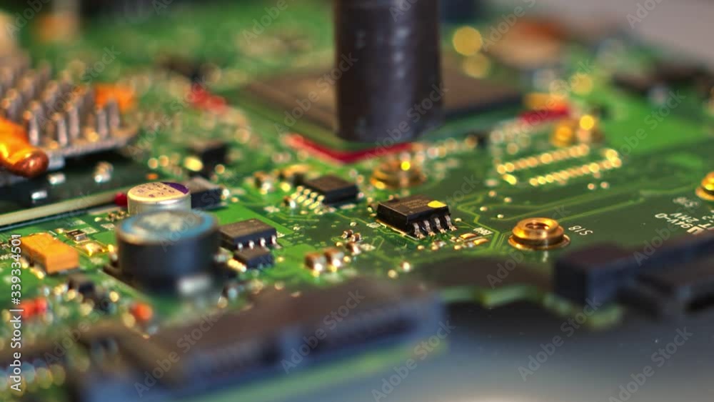 The repairman warms the chip with a burner in a circular motion ...