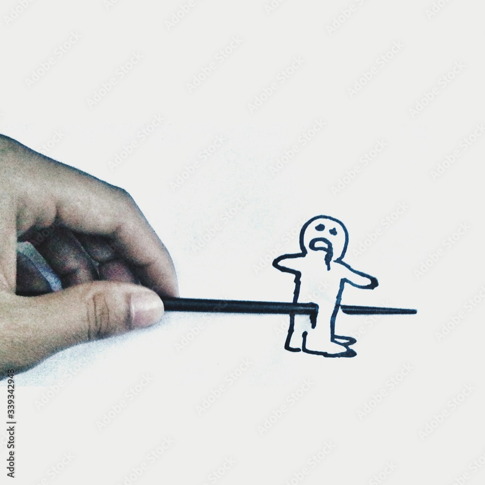 Optical Illusion Of Hand Stabbing Character On White Paper Stock Photo ...