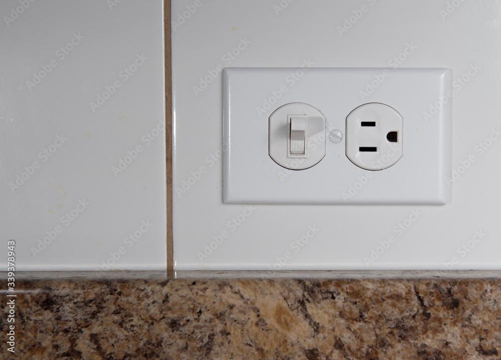 Electric receptacle with the light switch in a single device, installed ...