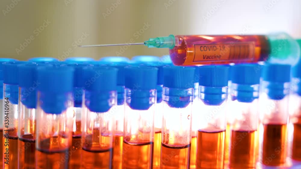 The fluids inside the test tubes and the syringe with coronavirus or ...