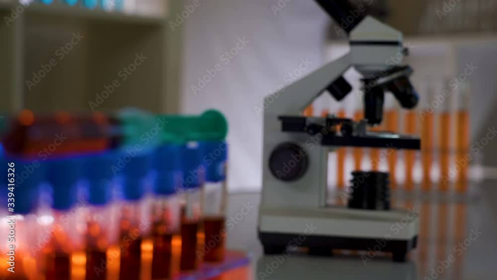 The microscope on the table with the syringe for coronavirus or Covid ...