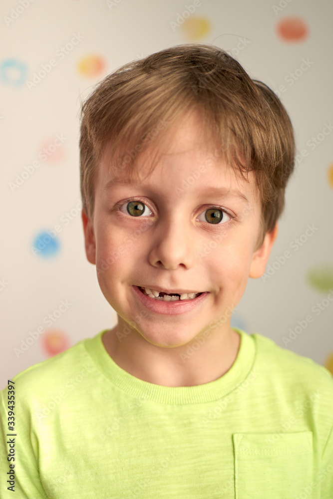 Kid showing missing teeth, he has lost two calfs teeth. Close up ...