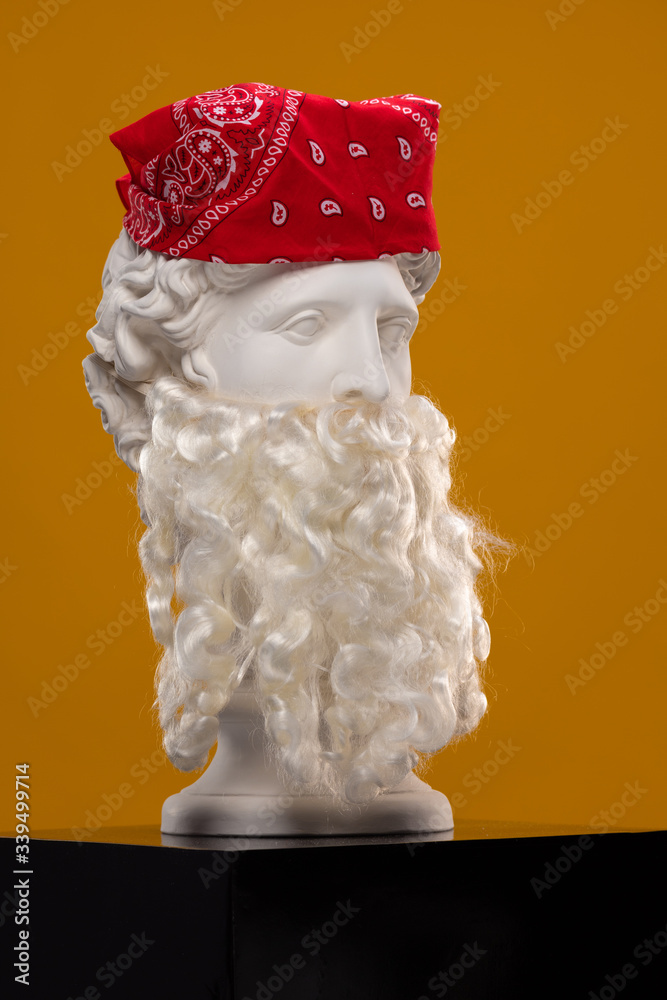 White plaster statue of a bust of Apollo Belvedere with a long white ...