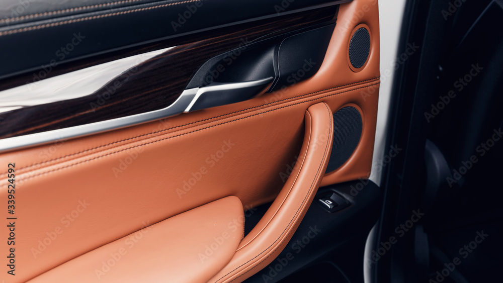 Car interior. Car door interior trim. Soft focus. Black and brown ...