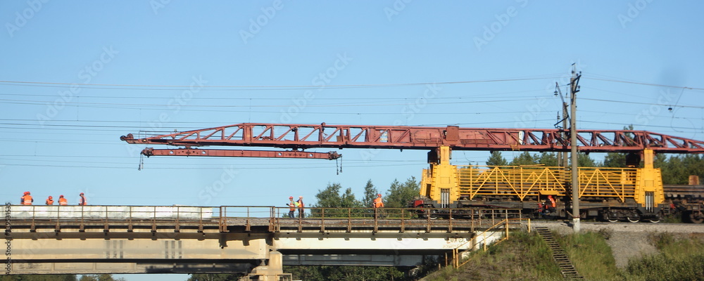 Russian rail loader crane on a railway bridge, replacement of rails ...