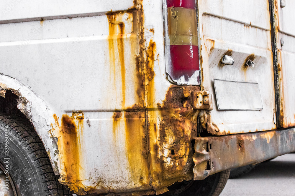 Rust on the rear wing of a white minibus, old rusty car Stock Photo ...