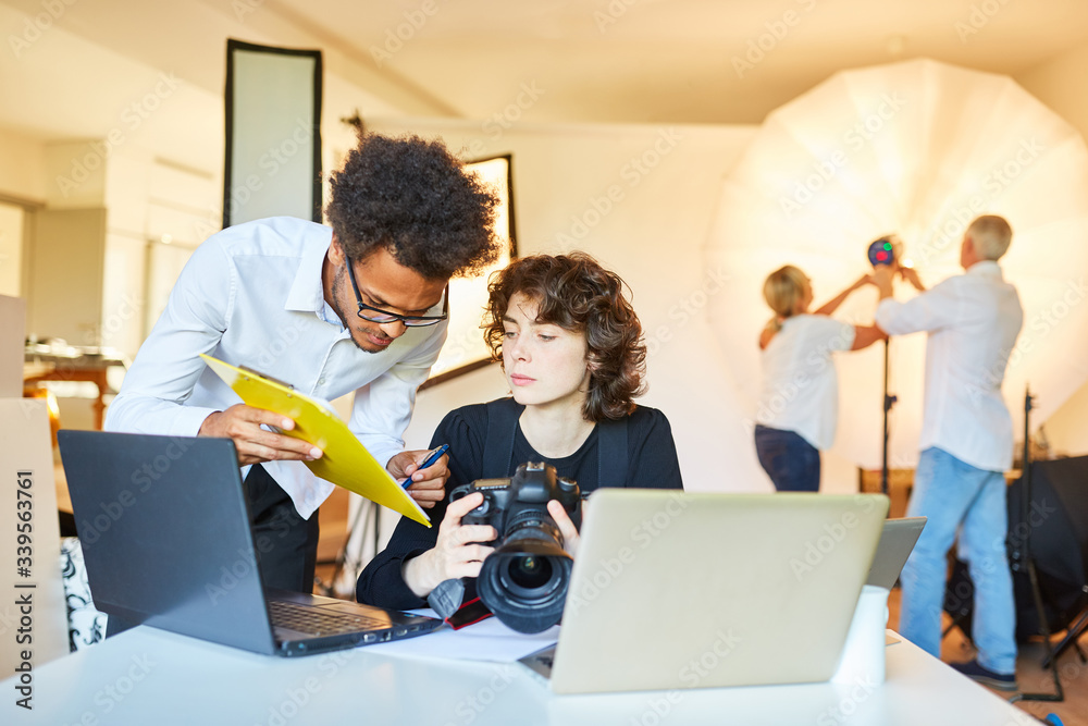 Photo assistant with clipboard and photographer Stock Photo | Adobe Stock