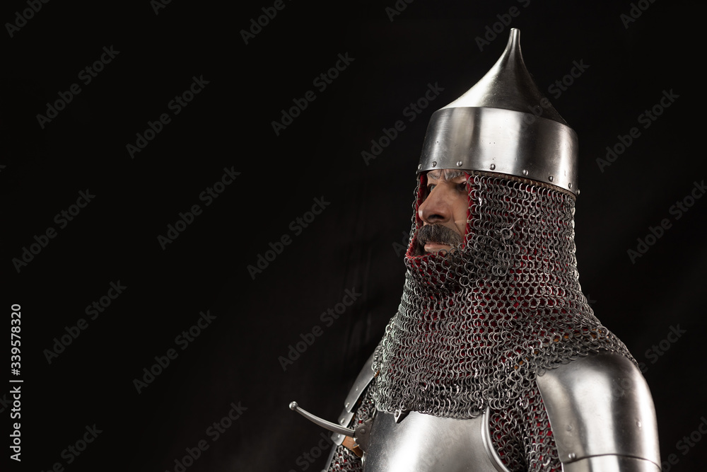 Mannequin man with a beard in a helmet and armor of a knight posing on ...