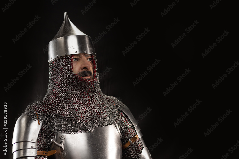 Mannequin man with a beard in a helmet and armor of a knight posing on ...