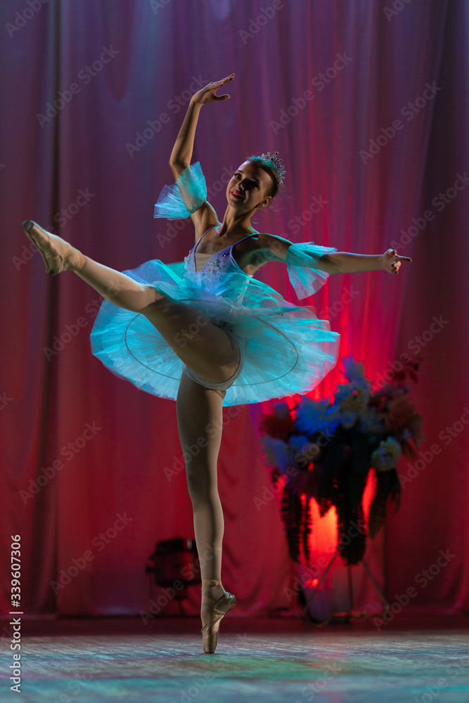 Young girl ballerina in a light blue dress tutu dancing performance of ...