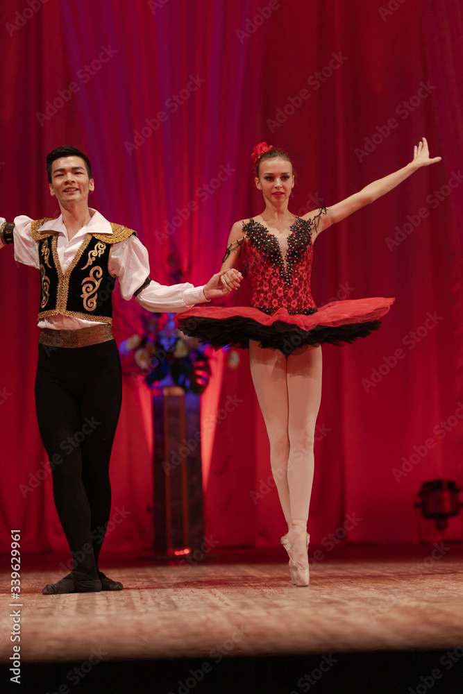 Duet young girl ballerina and a young man dancing ballet performance on ...