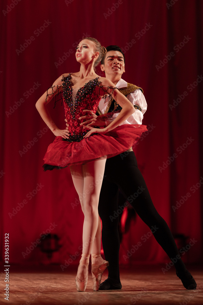 Duet young girl ballerina and a young man dancing ballet performance on ...