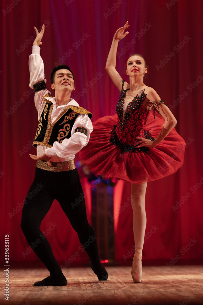 Duet young girl ballerina and a young man dancing ballet performance on ...